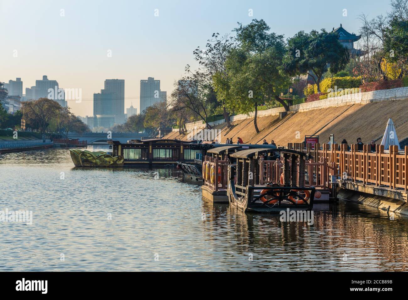 Riverside area with traditional Chinese boats outside the Ancient City ...