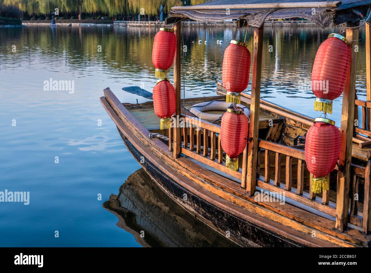 Traditional Chinese boat docked on the lake at Qujiangchi Relics Park ...