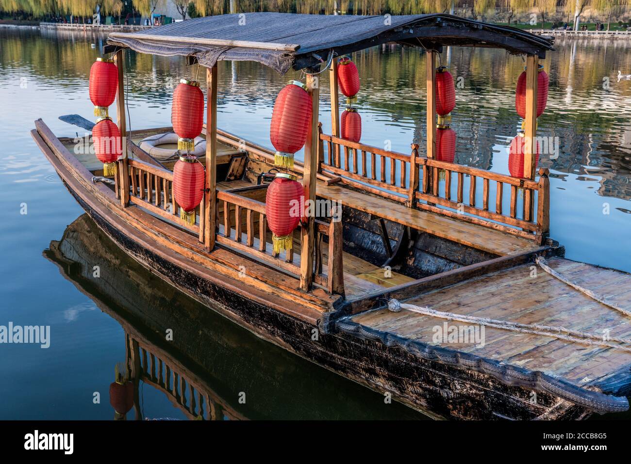 Traditional Chinese boat docked on the lake at Qujiangchi Relics Park ...