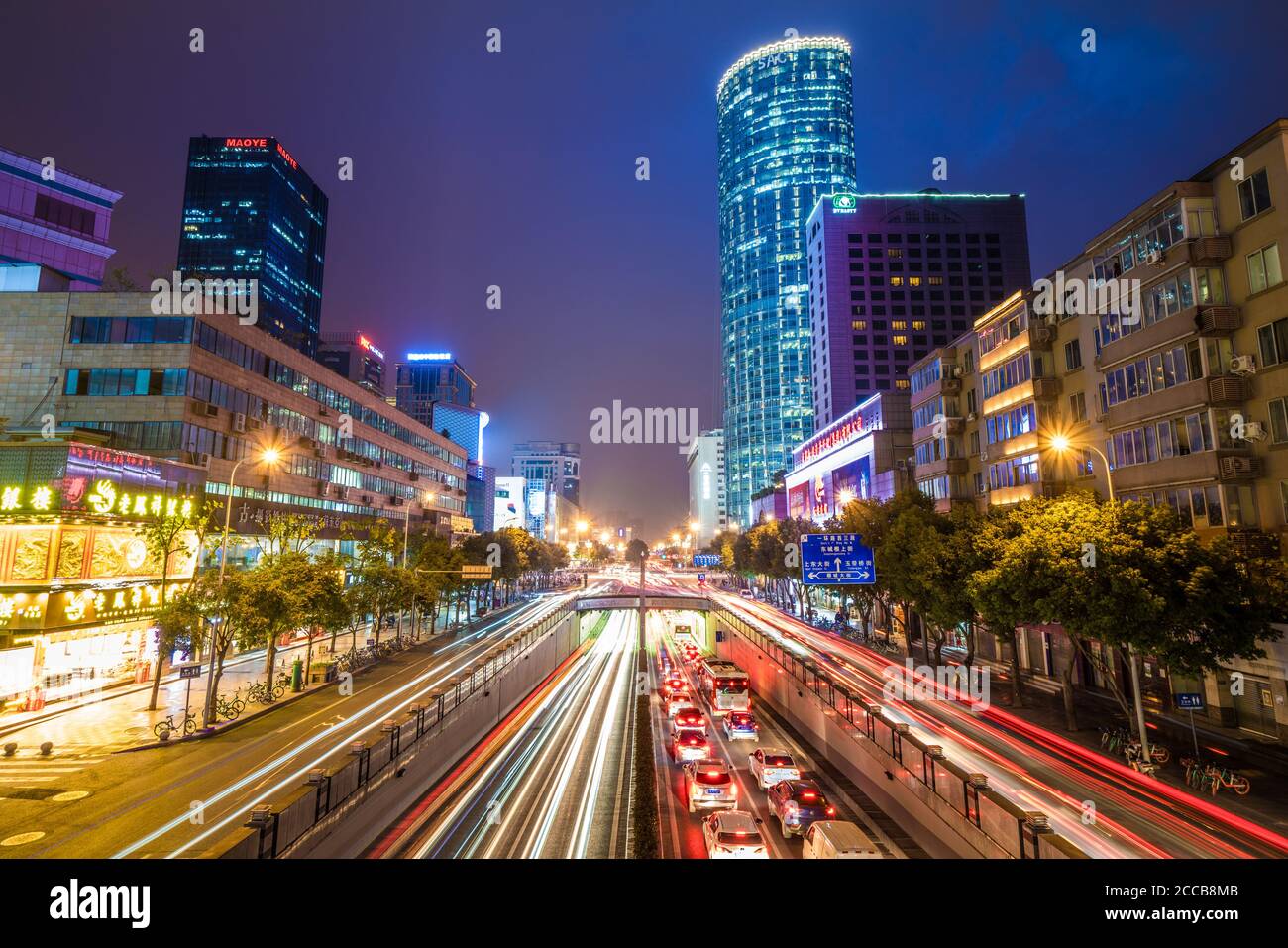 View of a downtown city road with light trails at night in Chengdu ...