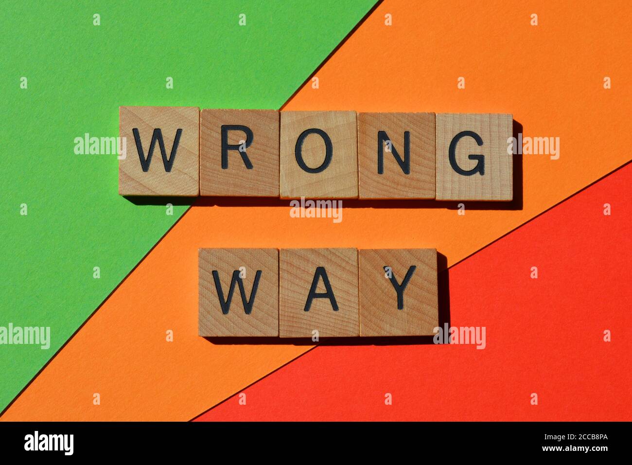 Wrong Way, word in wooden alphabet letters isolated on red, orange and ...