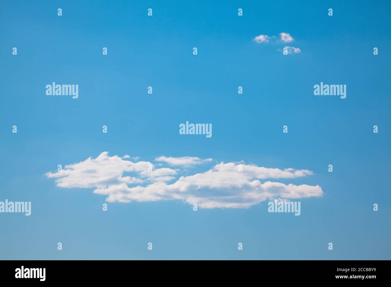 Minimum clouds . Clear blue daytime sky Stock Photo - Alamy