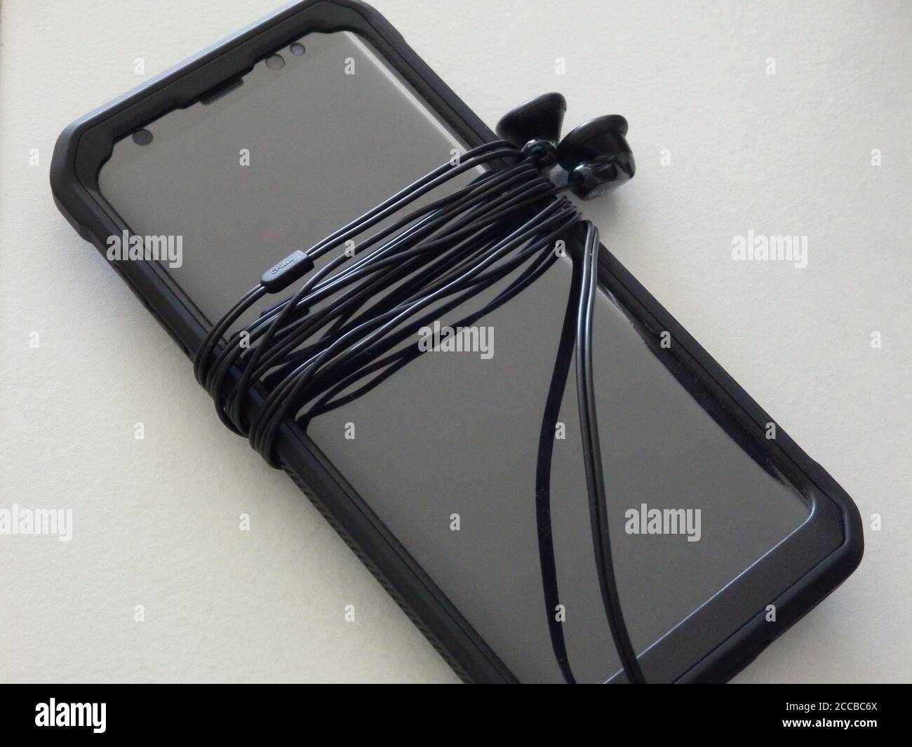 Android phone with earphone cord Stock Photo - Alamy