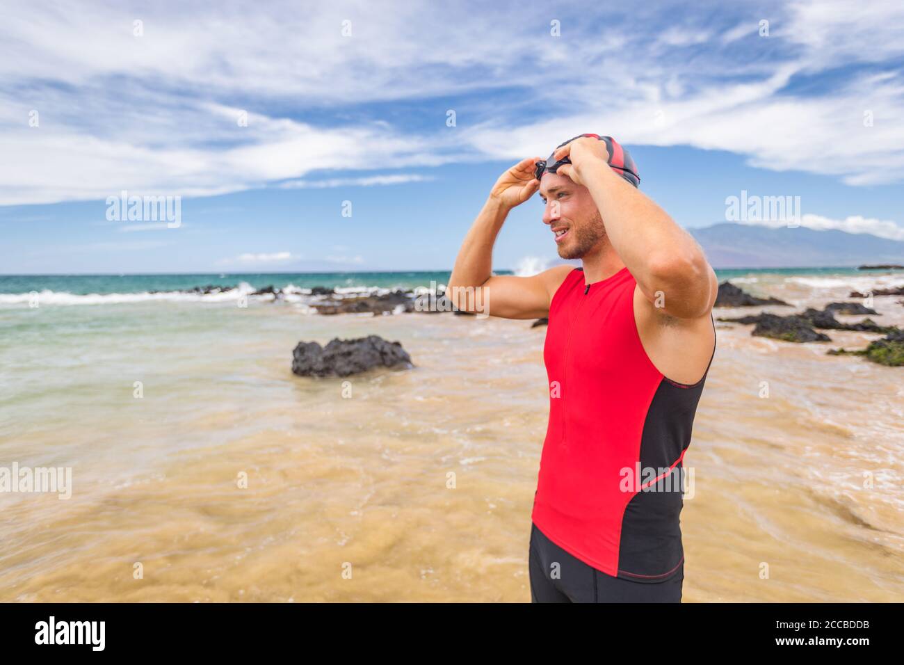 Man triathlete swimmer putting on swim goggles - Triathlon sport ...