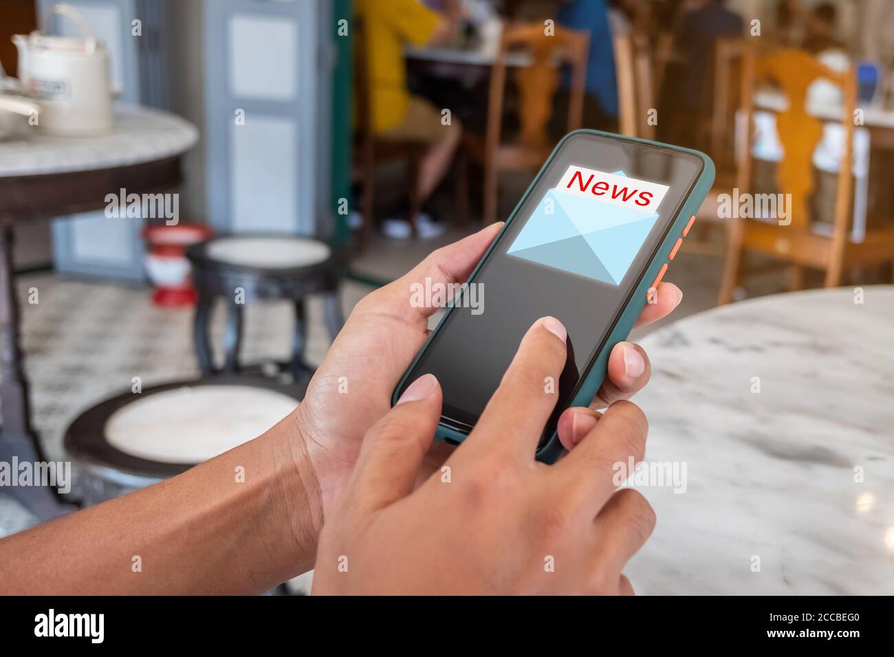 Woman hand using smartphone and it's show email recieve notification ...