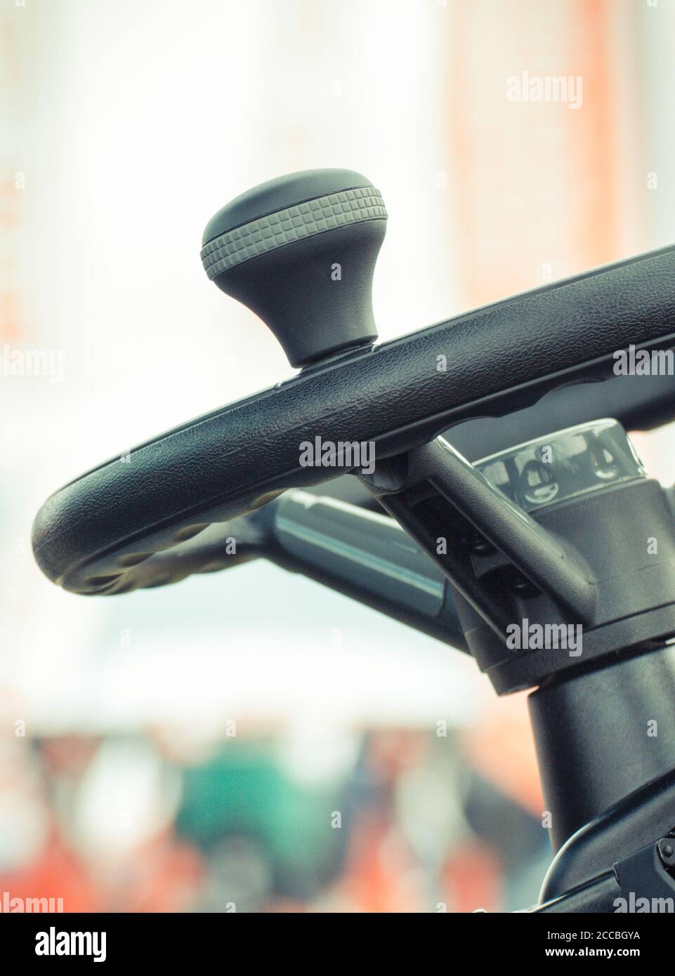 Black steering wheel in agricultural or industrial machine or vehicle ...