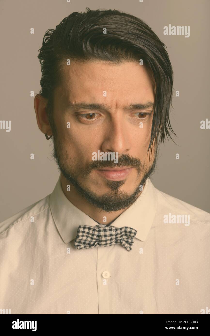 Face of handsome man thinking while looking down Stock Photo - Alamy