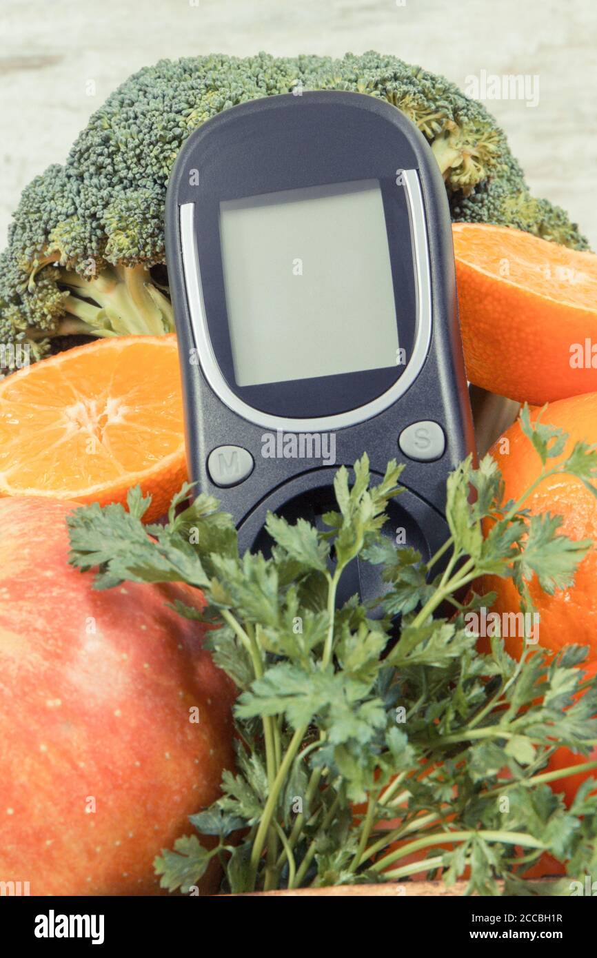 Glucometer and natural fruits with vegetables. Diabetes and nutritious ...
