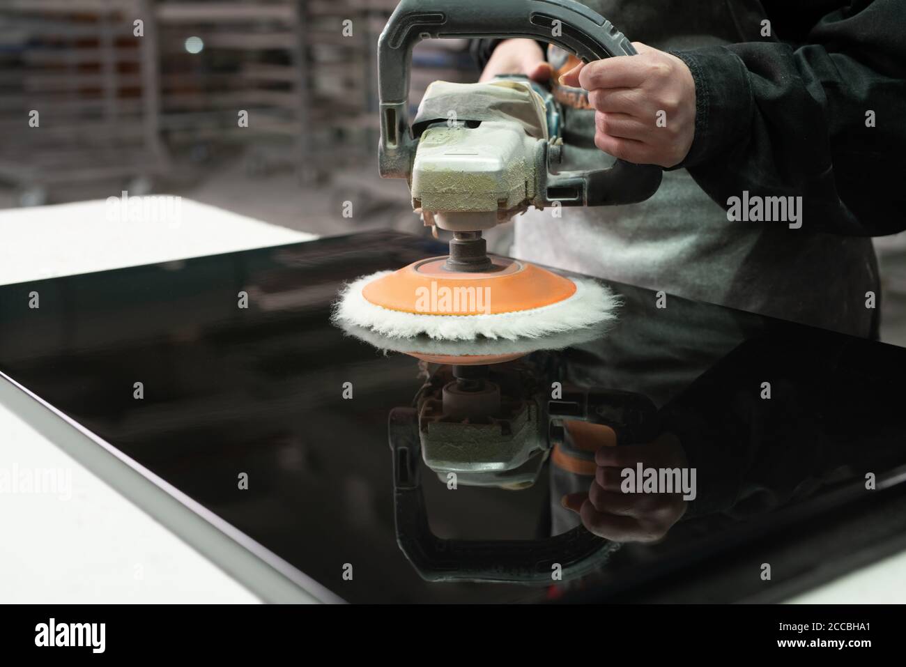 Polishing black wood panel with grinder machine Stock Photo - Alamy