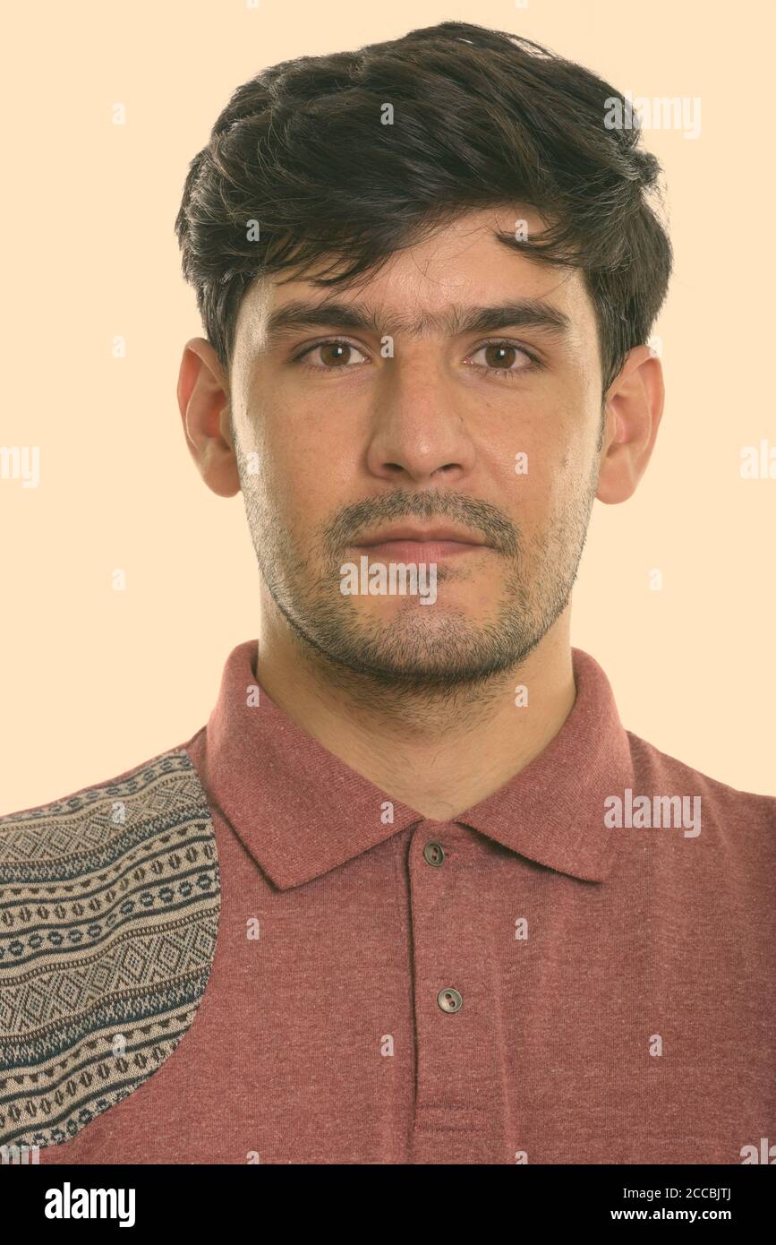 Studio shot of face of young Persian man Stock Photo - Alamy