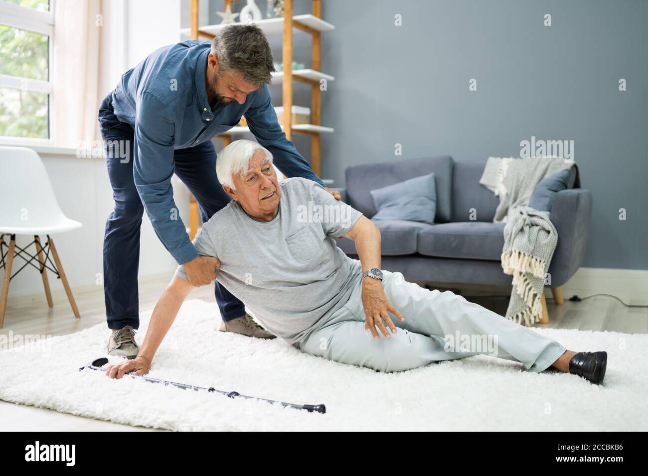 Helping Elder Senior Fallen Man After Fall Accident Stock Photo - Alamy
