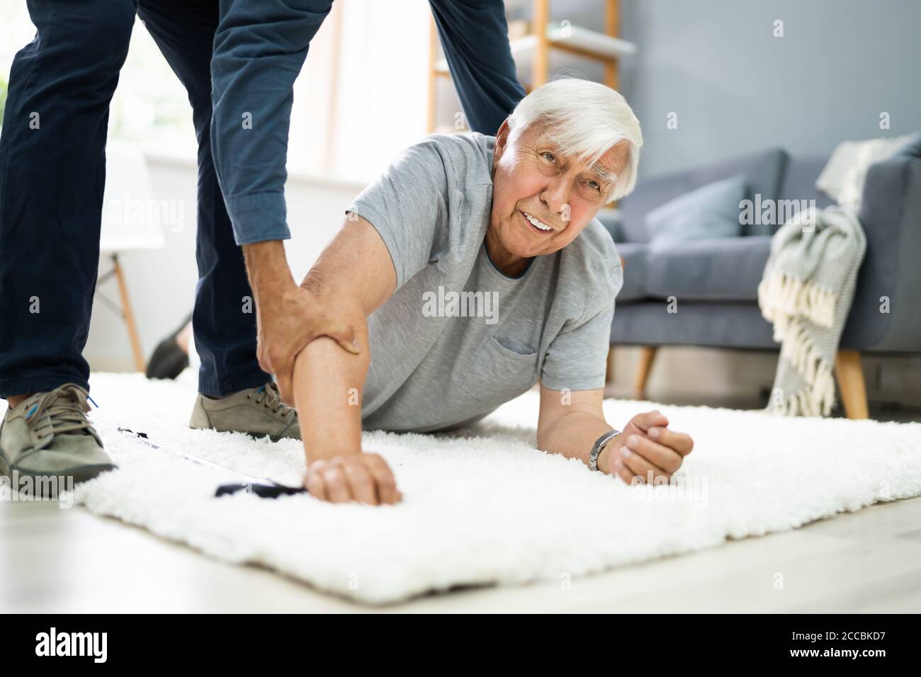 Helping Elder Senior Fallen Man After Fall Accident Stock Photo - Alamy