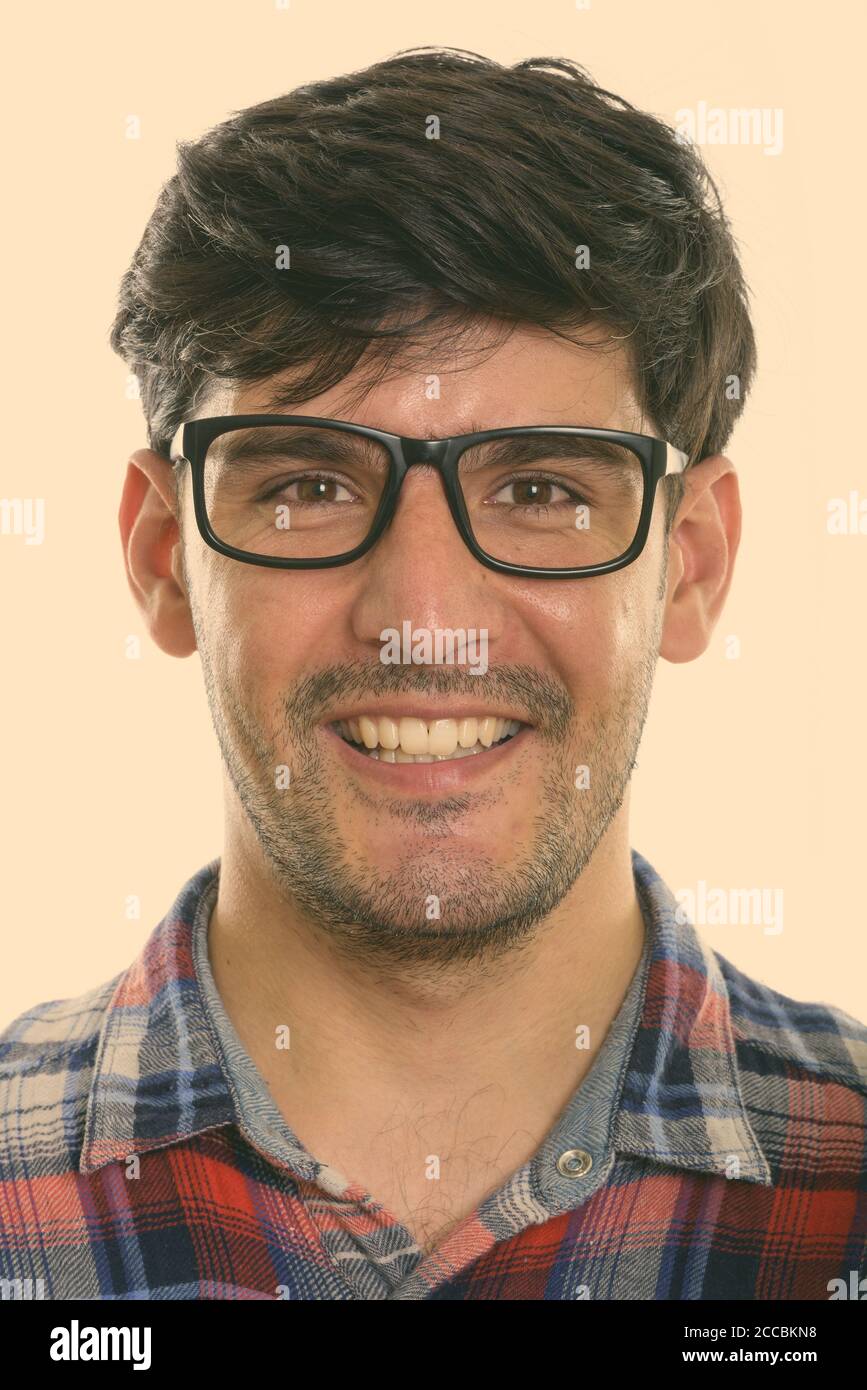 Face of young happy Persian man smiling while wearing eyeglasses Stock ...