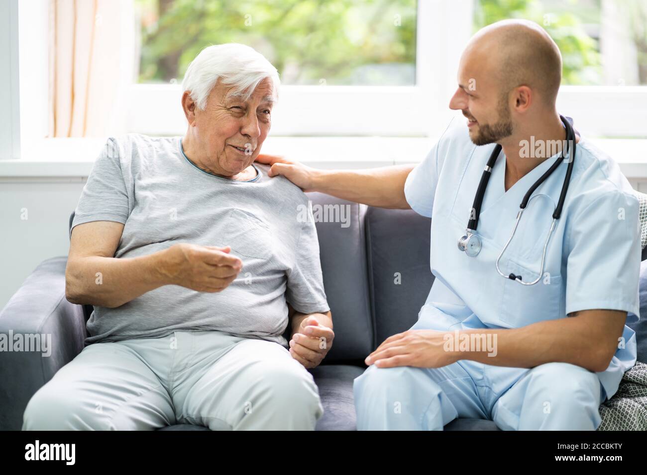 Old Senior Home Care Patient With Nurse At Home Stock Photo - Alamy