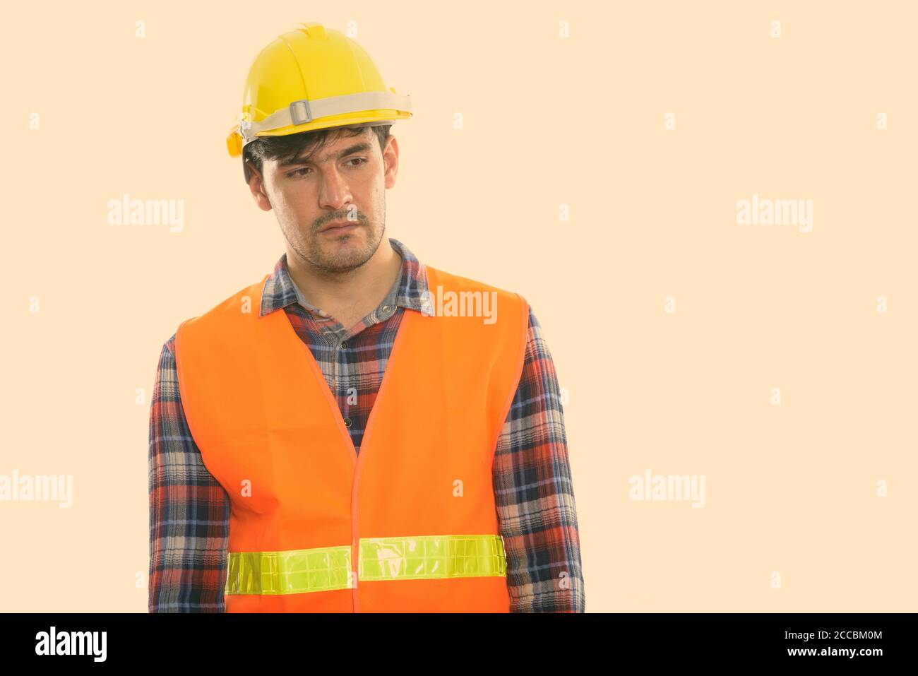 Young Persian man construction worker thinking while looking sad Stock ...