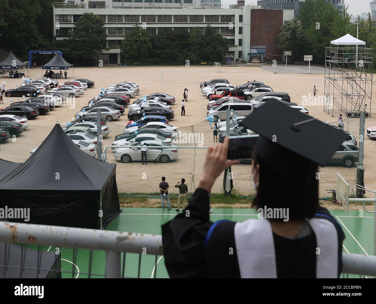 21st Aug, 2020. Drive-in graduation ceremony A graduating senior ...