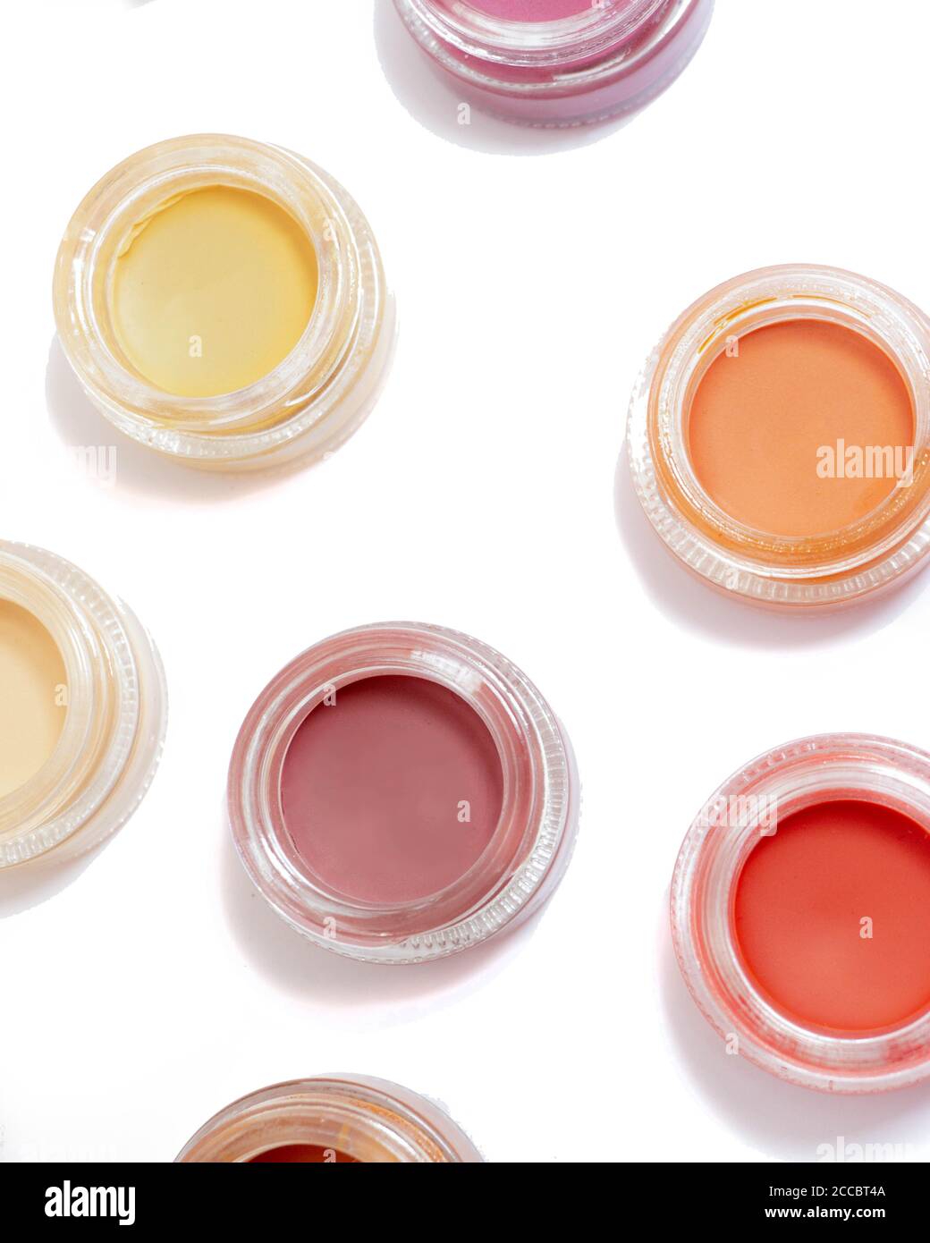 Paints in small transparent containers isolated on a white background ...