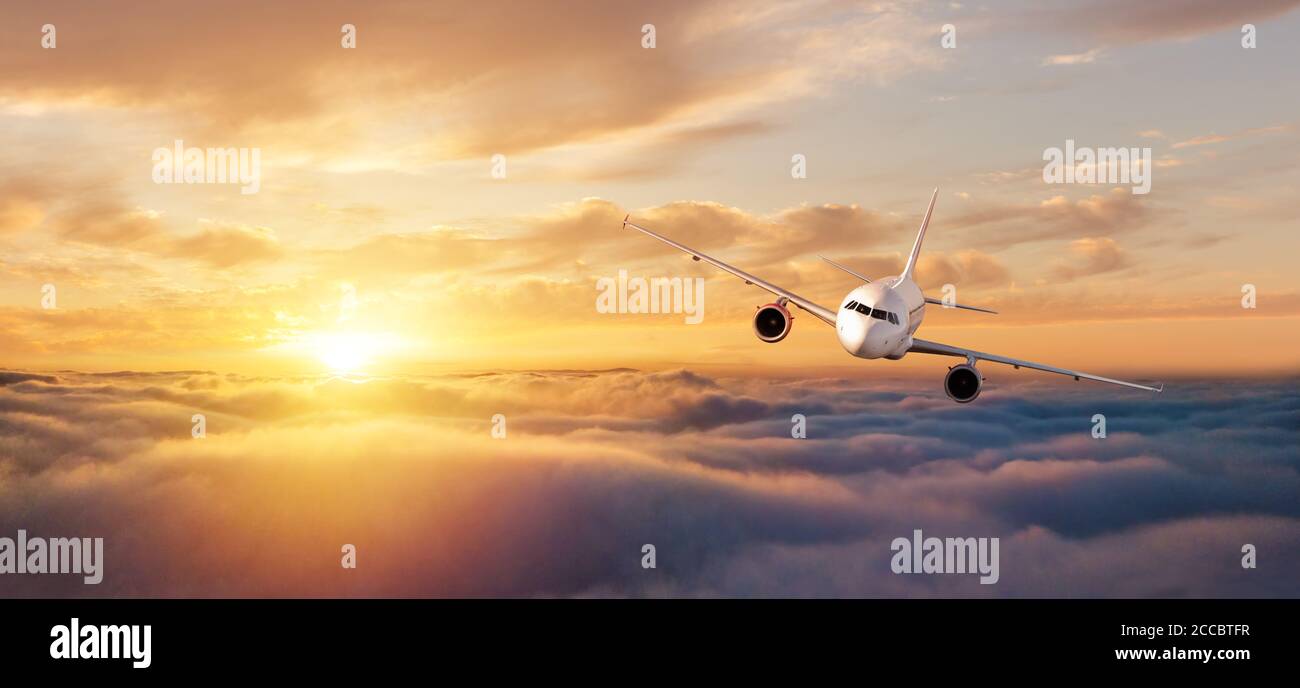 Commercial airplane flying over dramatic sunset sky. Jet plane is the ...