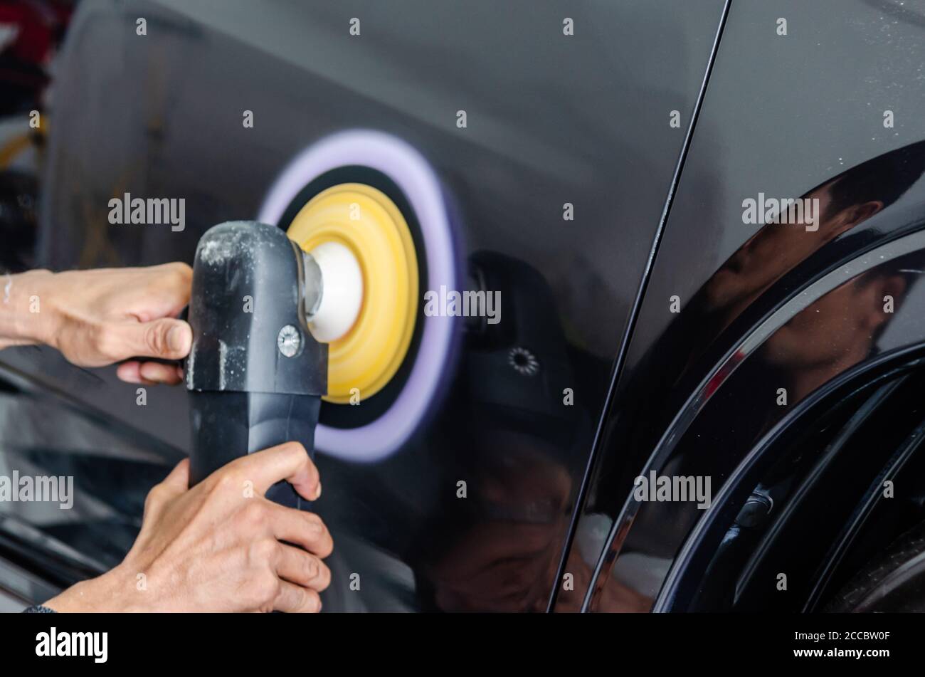 Man hands holding the work tool polish the car.Buffing and polishing ...
