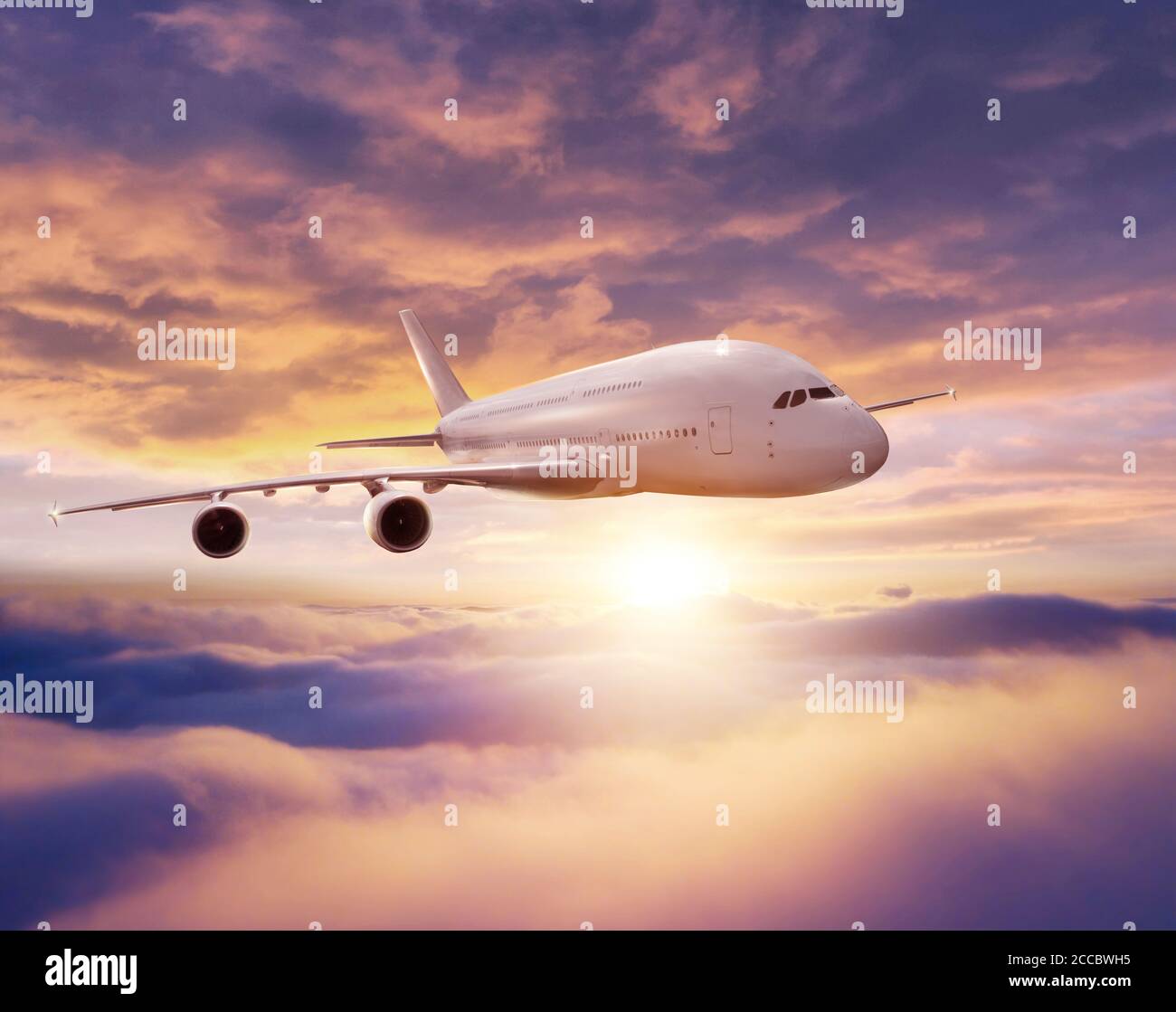 Huge commercial airplane flying over dramatic sunset sky. Jet plane is ...