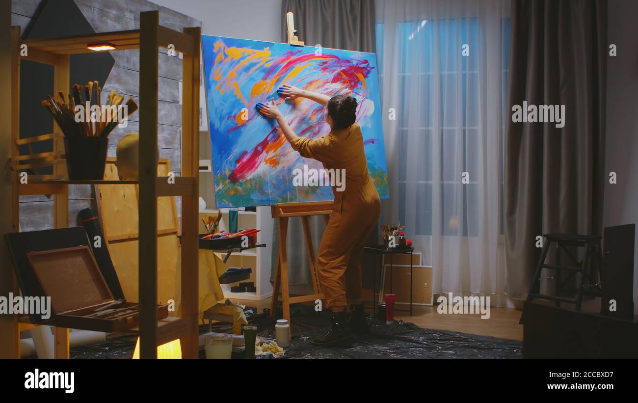 Painter using fingers on large canvas making a masterpiece in art ...