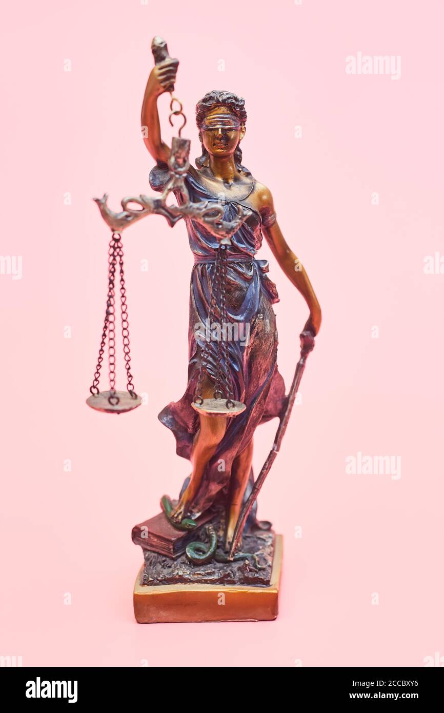 Bronze statue of Themis on a pastel pink background, copy space Stock ...