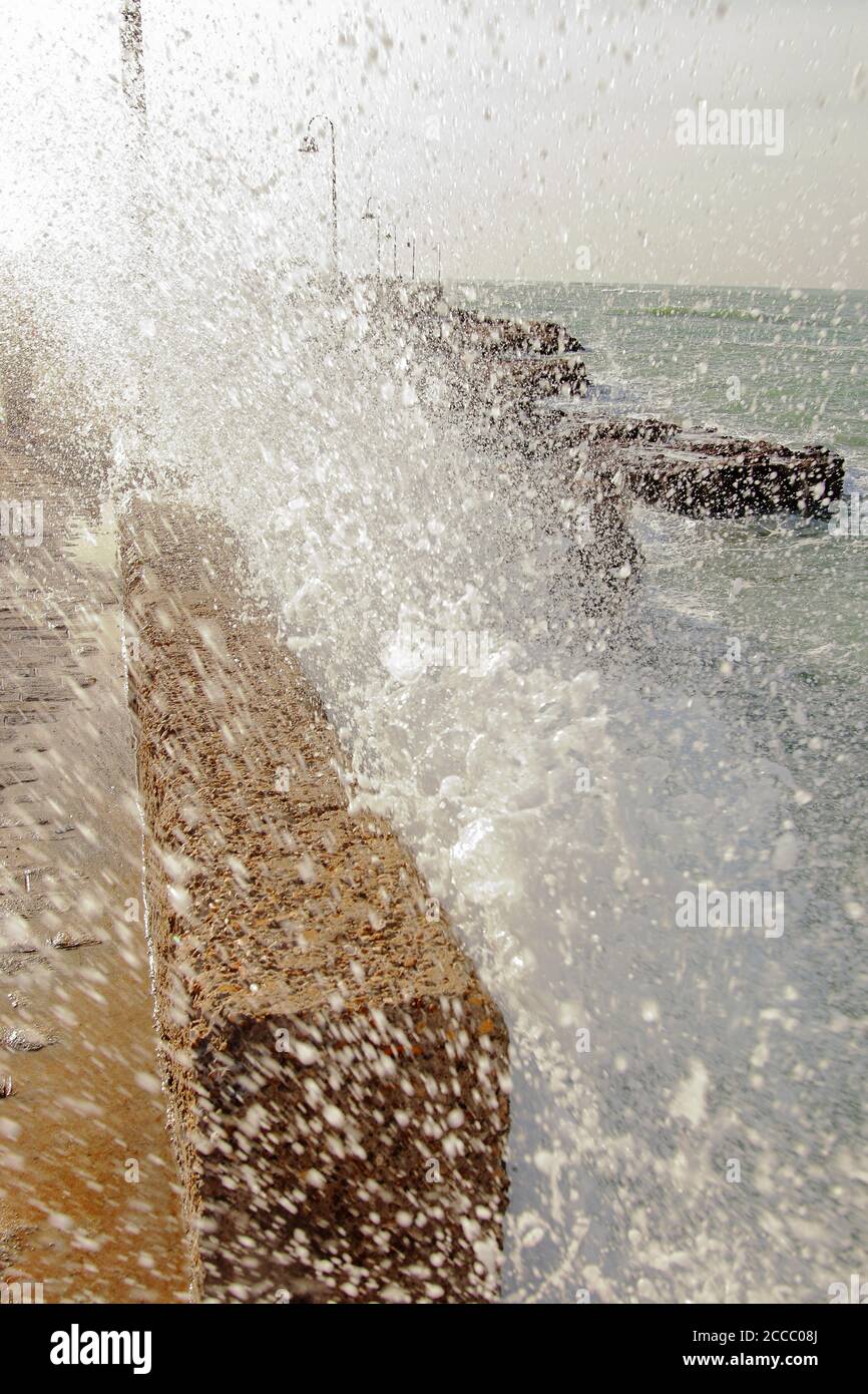Vertical shot of a wave hitting rocks Stock Photo - Alamy
