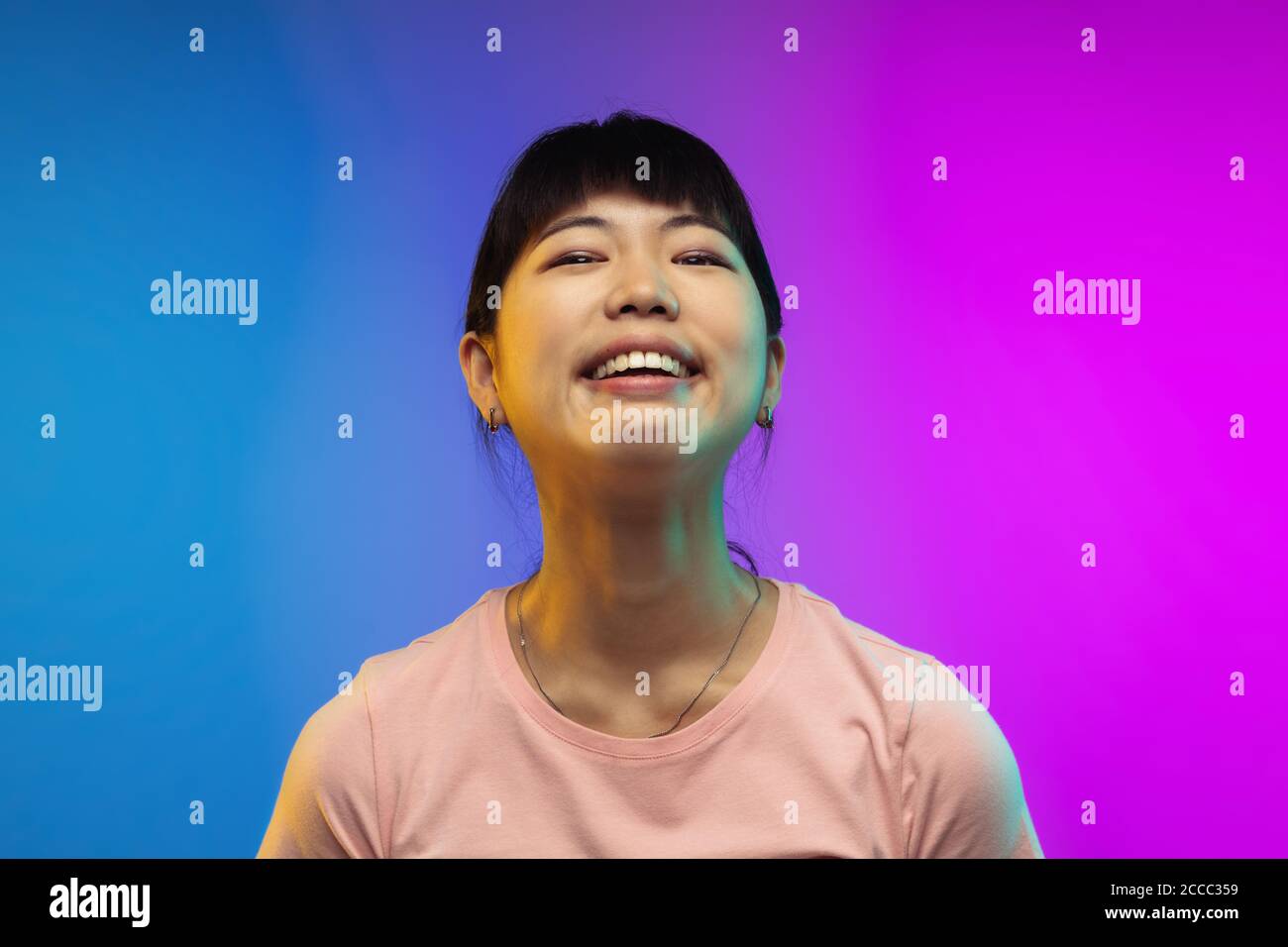 Happy. Close up asian young woman's portrait isolated on gradient ...