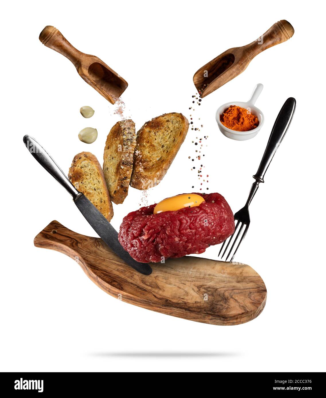 Flying tartar steak with spice and toasts. Concept of flying food in ...