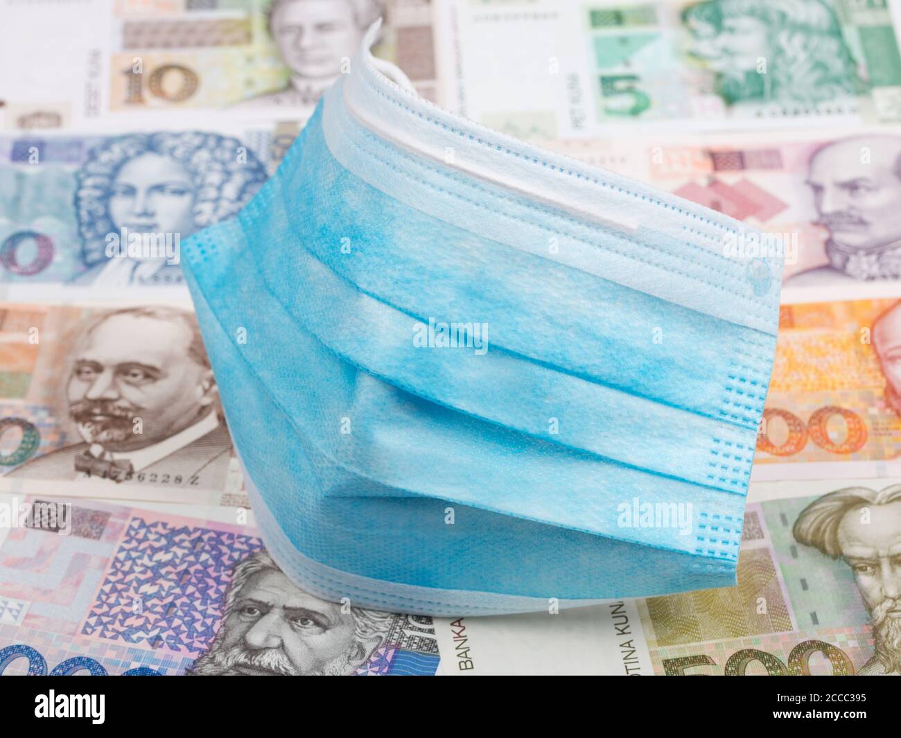 Protective mask on a Croatian money Stock Photo - Alamy