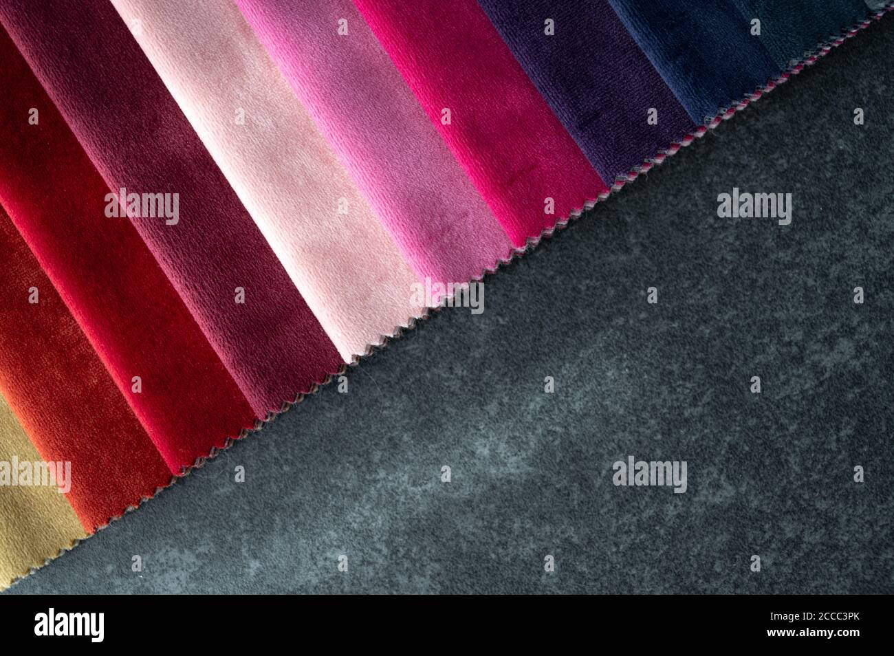 Color gradients of velvet samples on fabric swatch placed on a dark ...