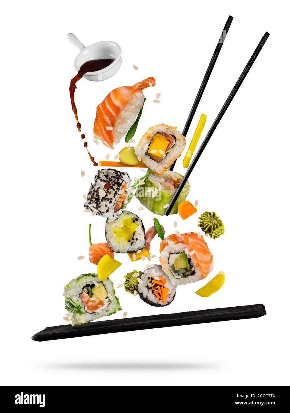 Sushi pieces placed between chopsticks, separated on white background ...