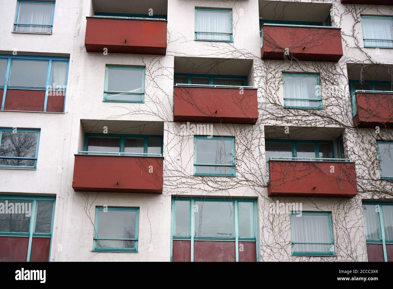 View of windows and balconies of a tenement building Stock Photo - Alamy