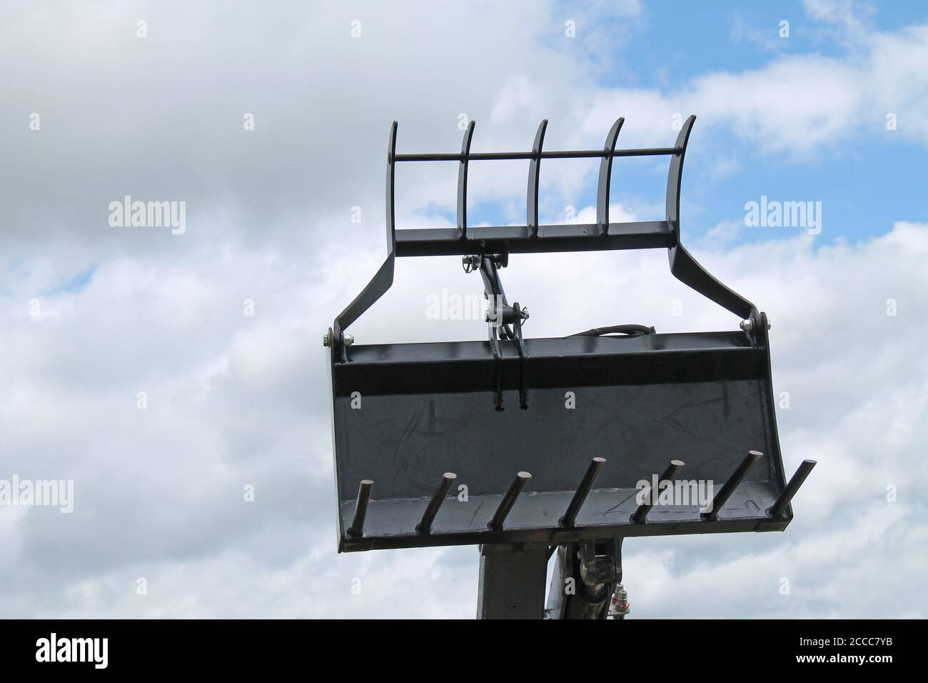 An Agricultural Grass Grab on an Hydraulic Tractor Arm Stock Photo - Alamy