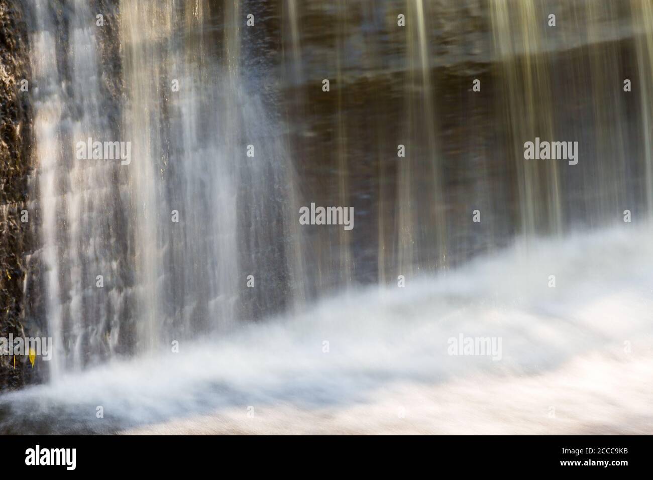 Waterfall over a dam wall Stock Photo - Alamy