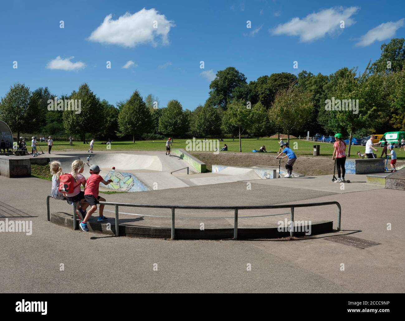 Summer Skatepark - Children Watching & Playing on their scooters in ...