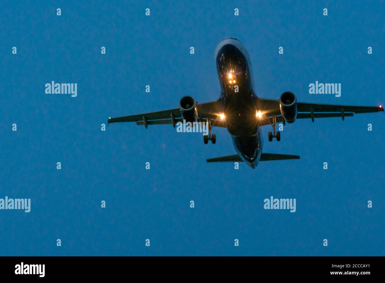 Airplane immediately after take off from airport, sky view at night ...