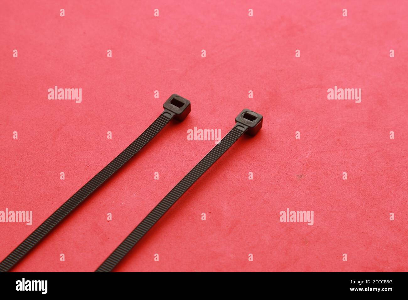 Closeup of adjustable plastic clamps on a red surface under the lights ...