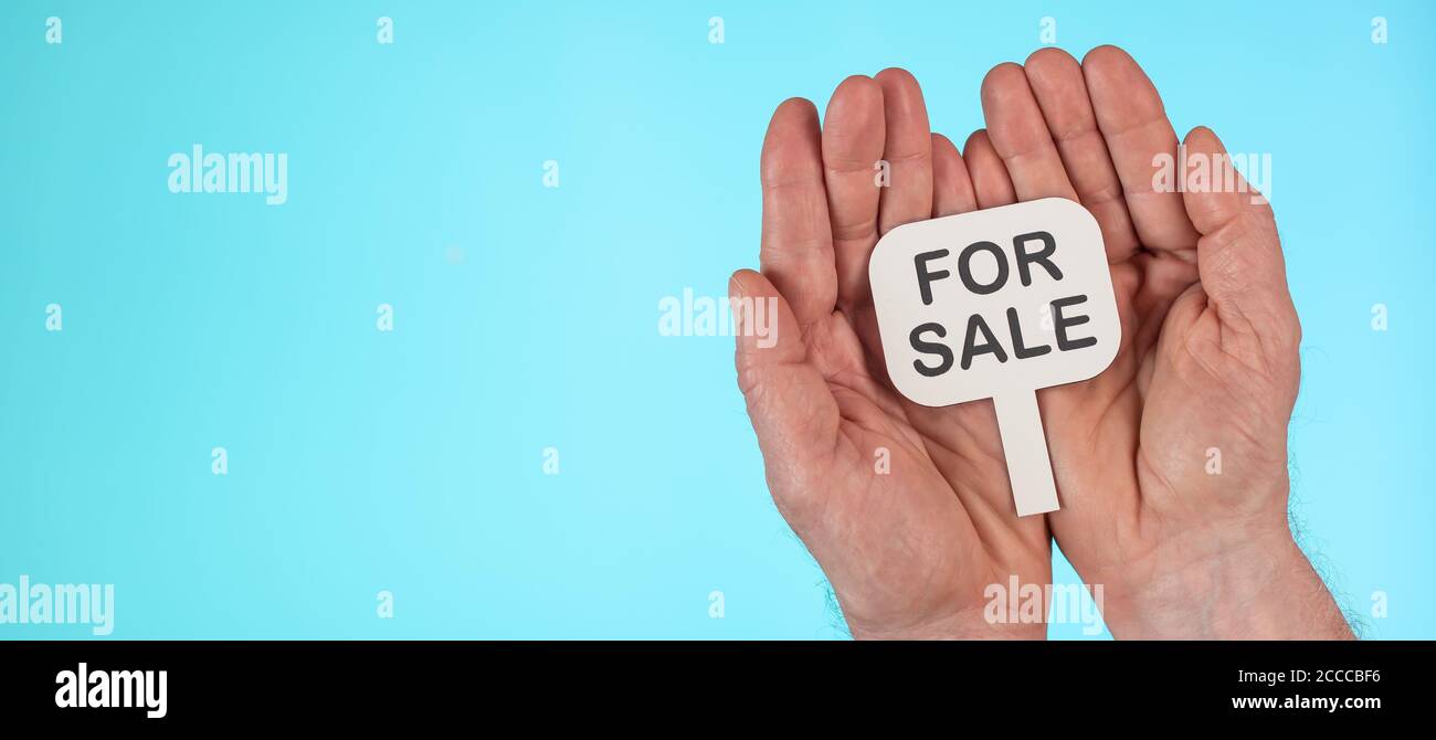 Hands holding sign sold hi-res stock photography and images - Alamy