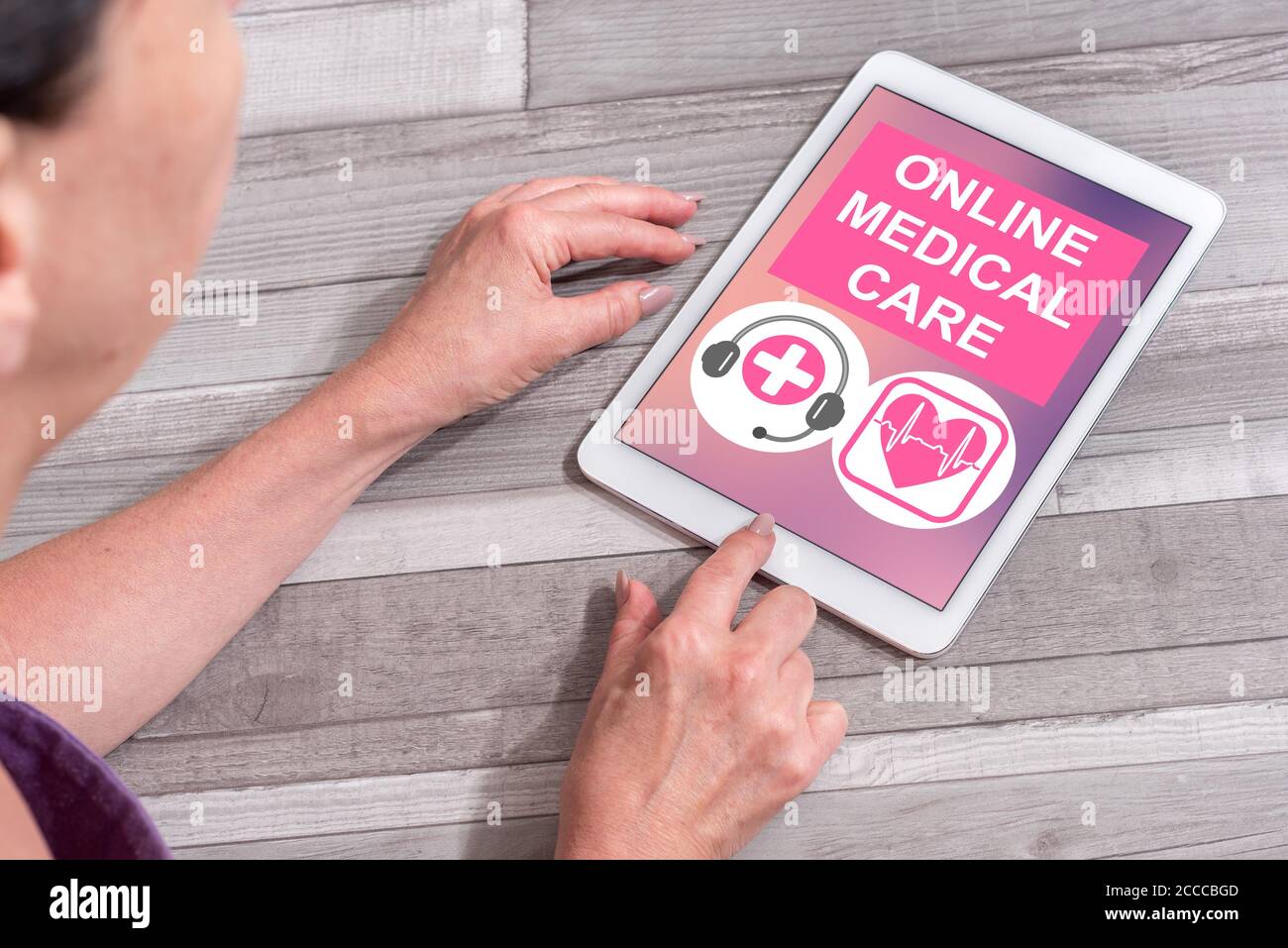 Woman using a tablet showing online medical care concept Stock Photo ...