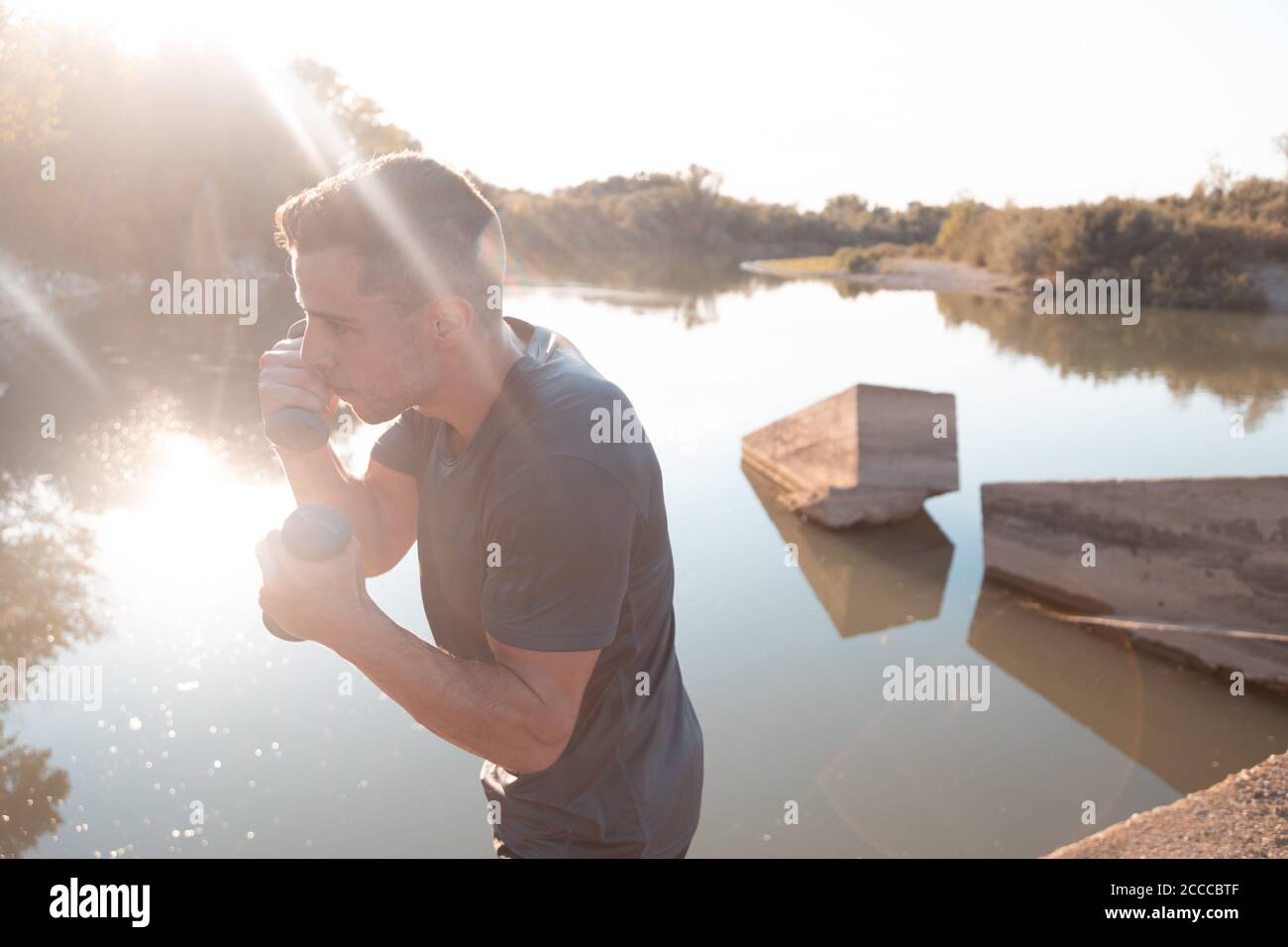 Closeup shot of a male training next to the river Stock Photo - Alamy