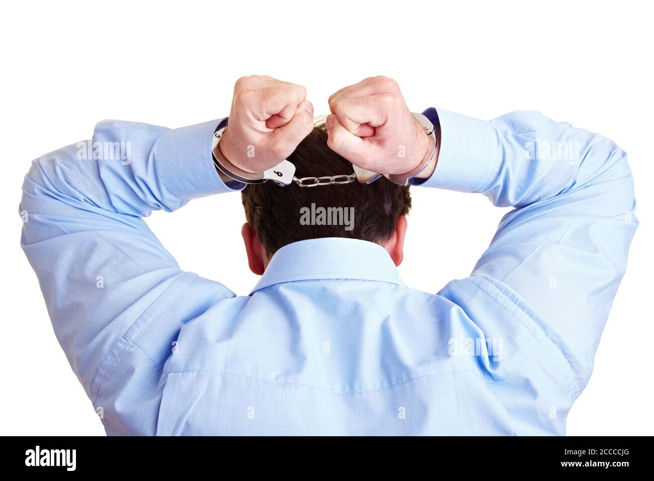 Manager clenches his fists in handcuffs from behind Stock Photo - Alamy