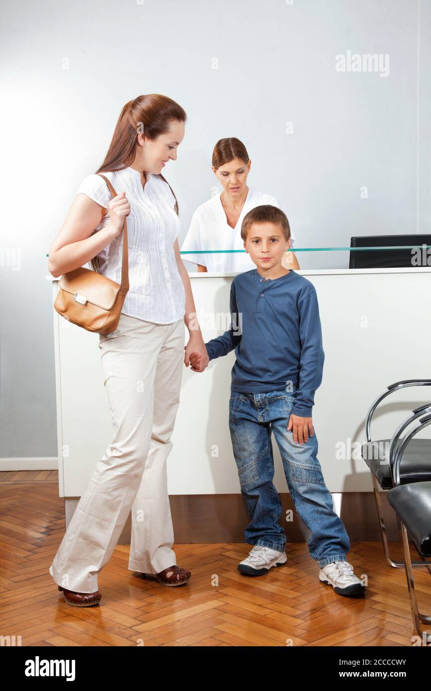 Mother with child on hand stands at a counter Stock Photo - Alamy
