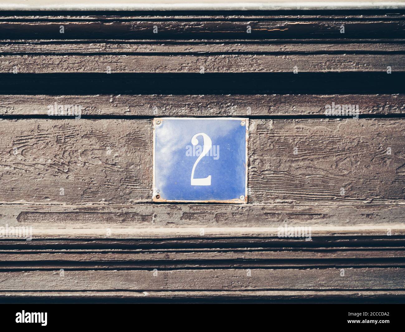 Old house number sign placed on the wooden wall Stock Photo - Alamy