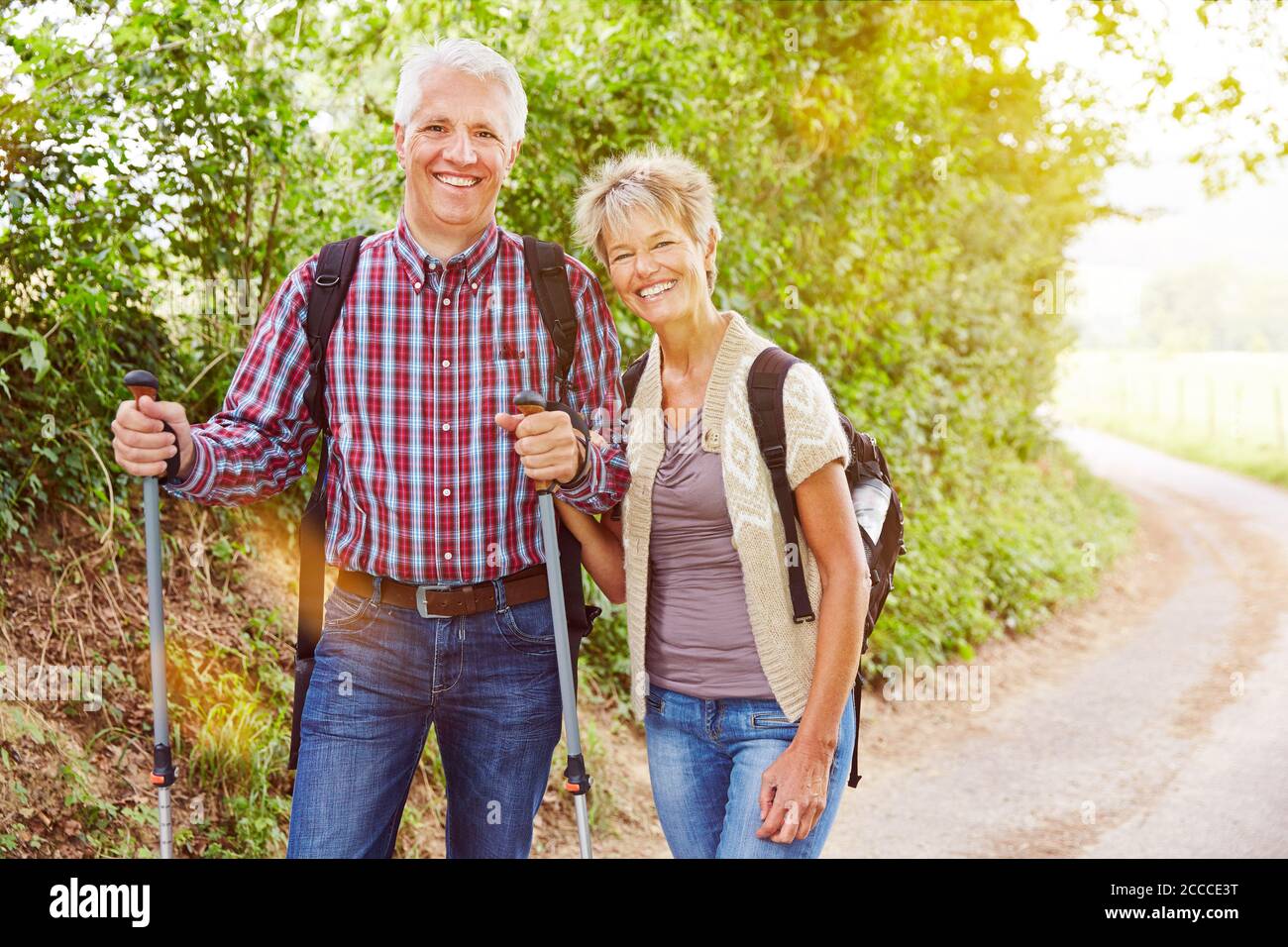 Two happy seniors walking together in autumn Stock Photo - Alamy