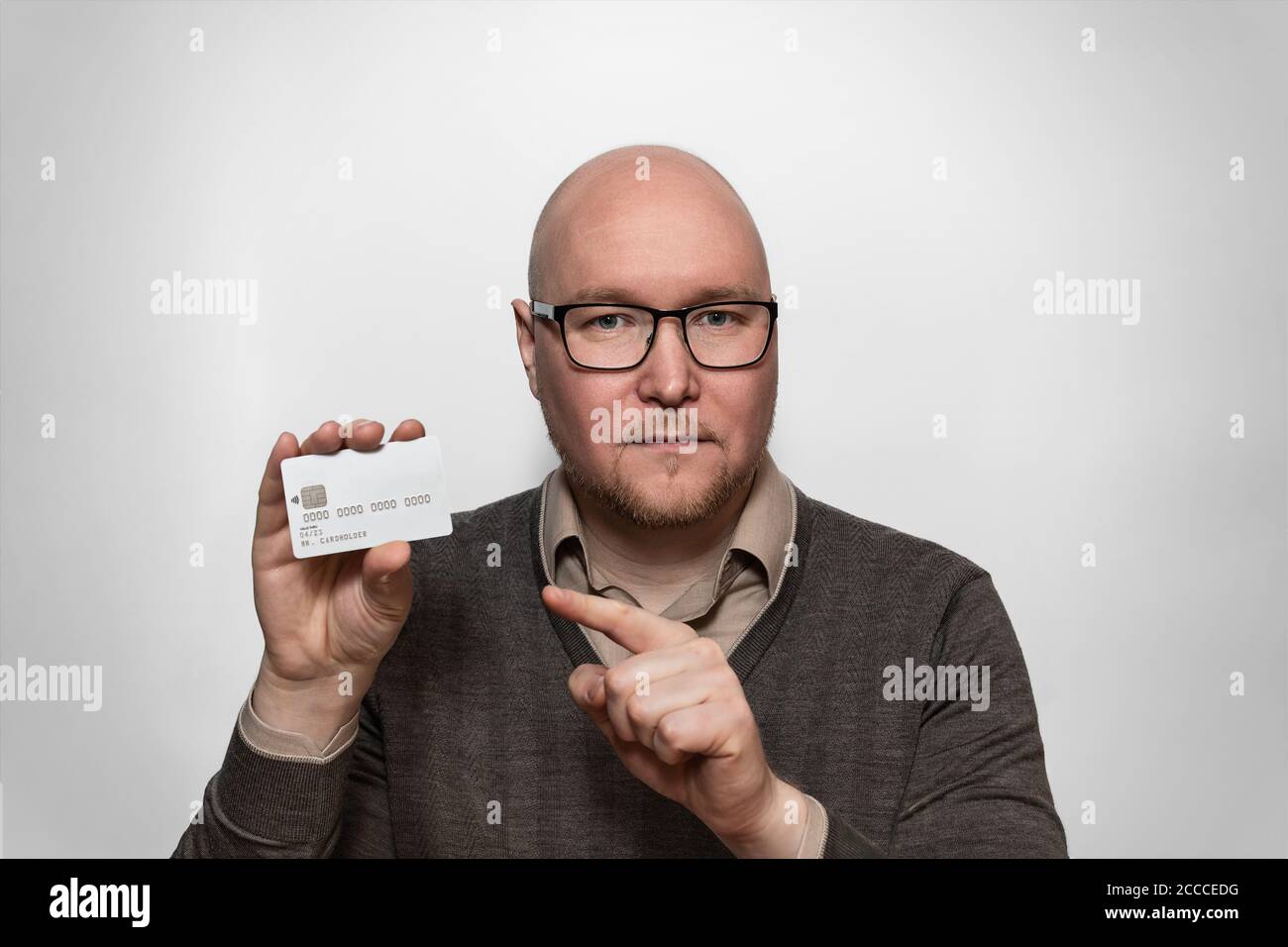 Man holding white credit card on gray background Stock Photo - Alamy