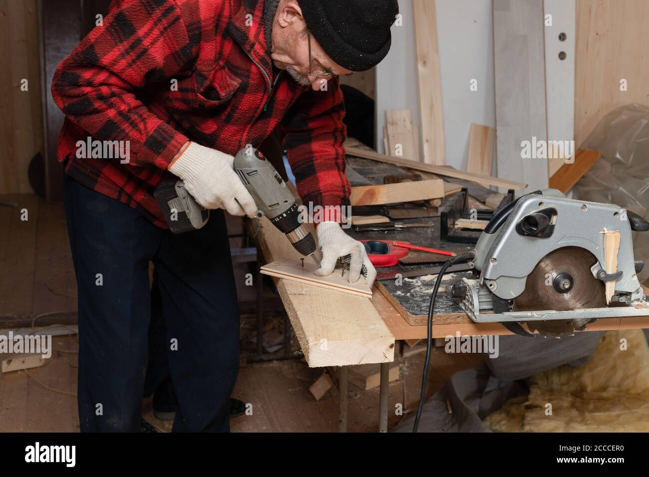 Senior man works as a carpenter in the workshop. Active old age Stock ...