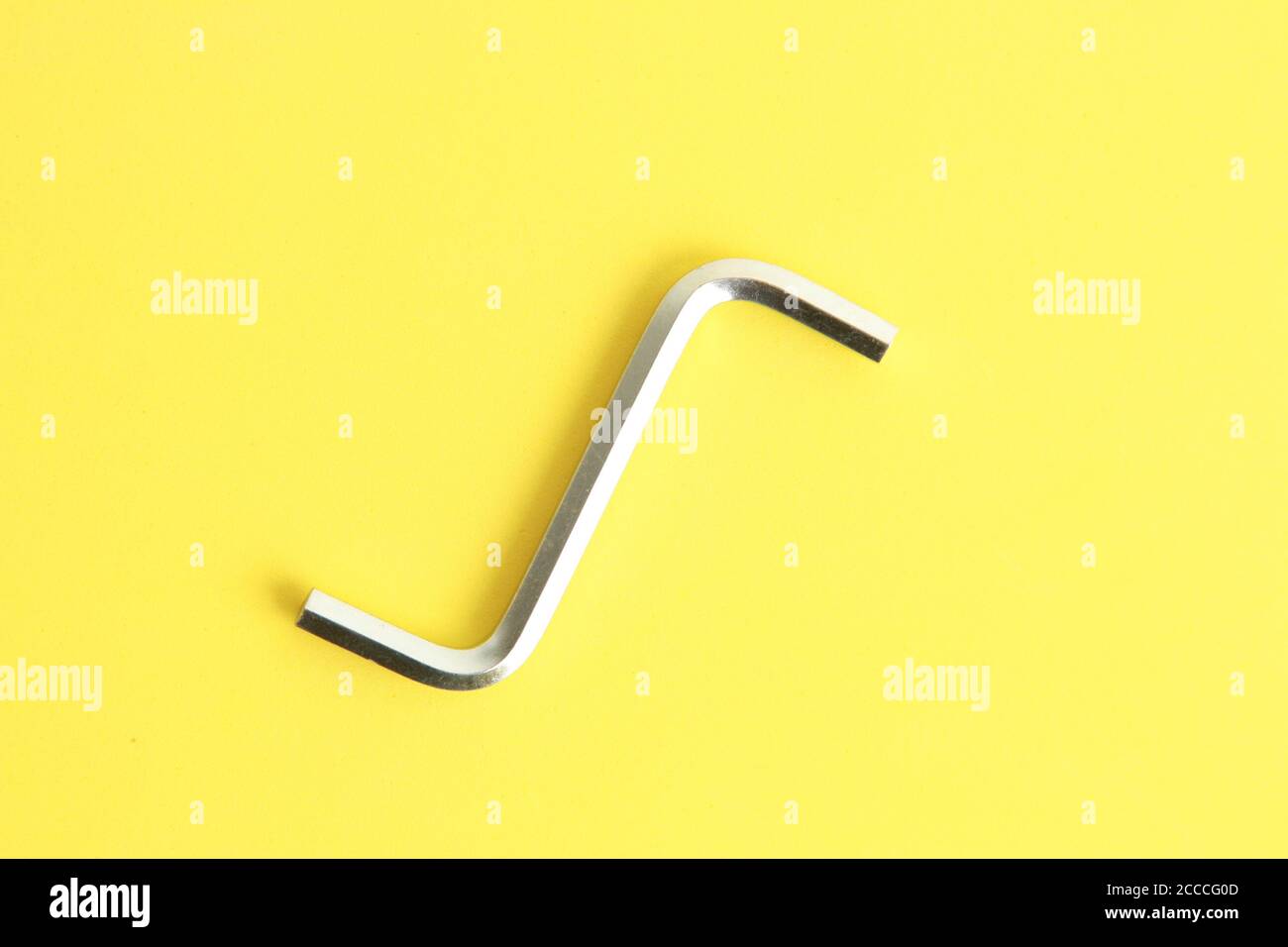 Top view of an allen key for assembling furniture on yellow background ...