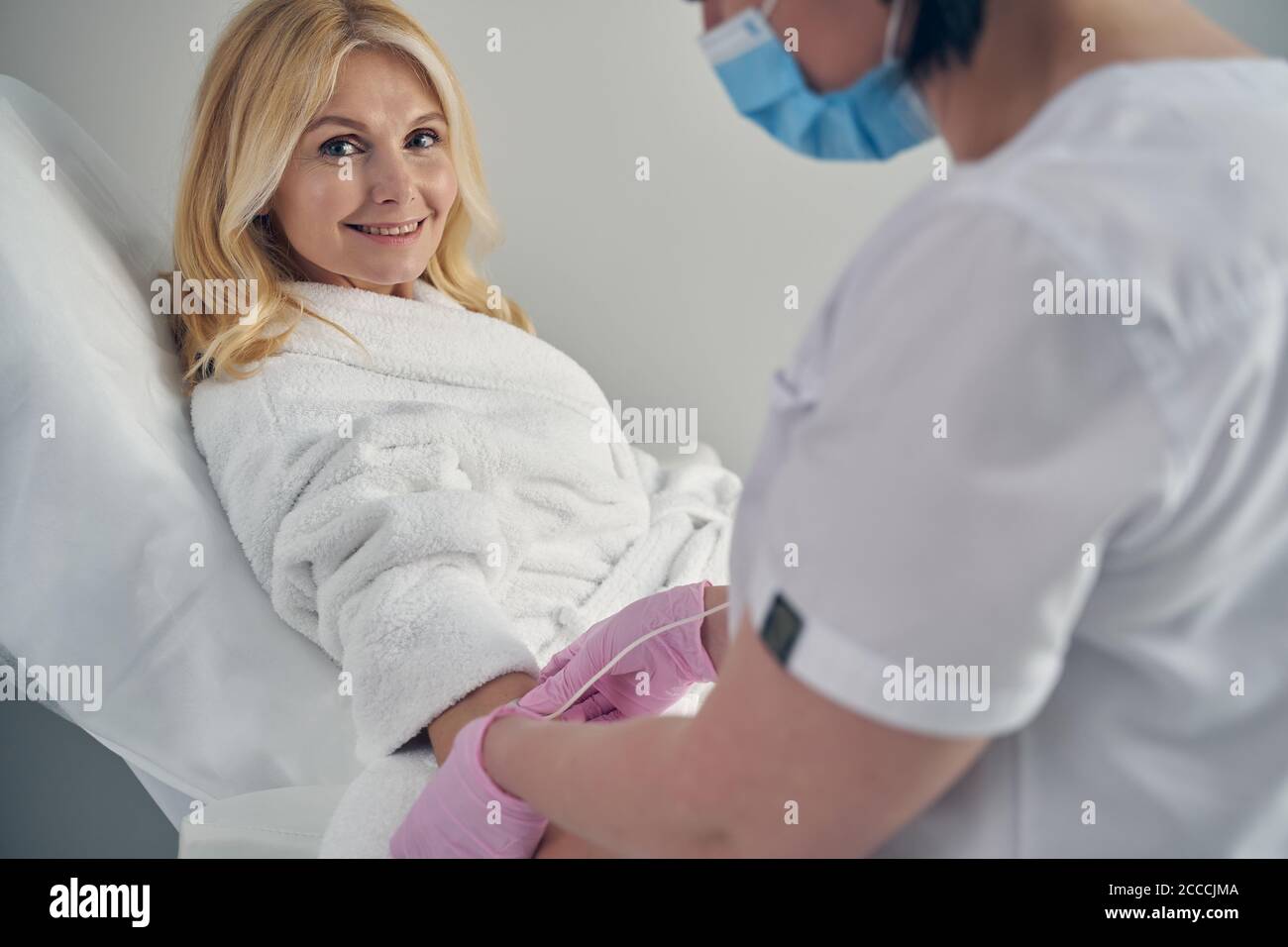 Cheerful female expecting beauty treatment in professional clinic Stock ...