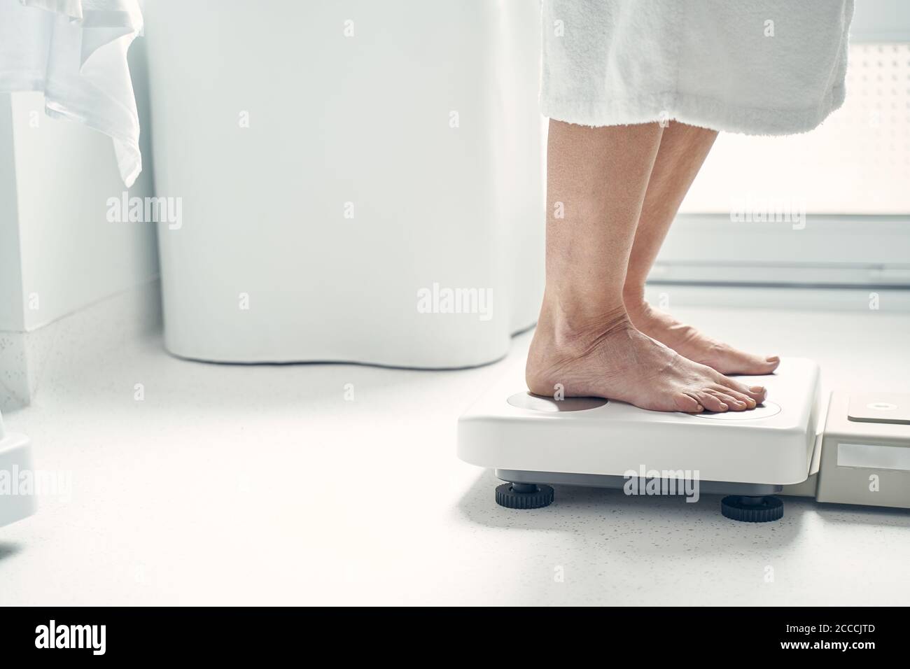 Mature female checking her body condition in clinical ward Stock Photo ...